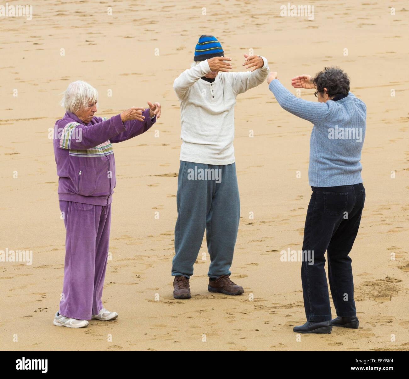 Three elderly people appear to be hugging Invisible trees as they ...