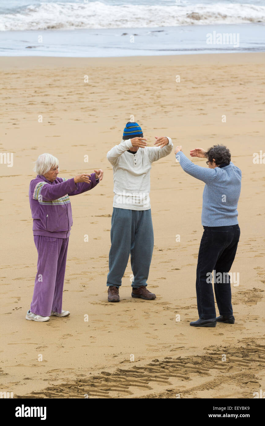 Three elderly people appear to be hugging Invisible trees as they ...