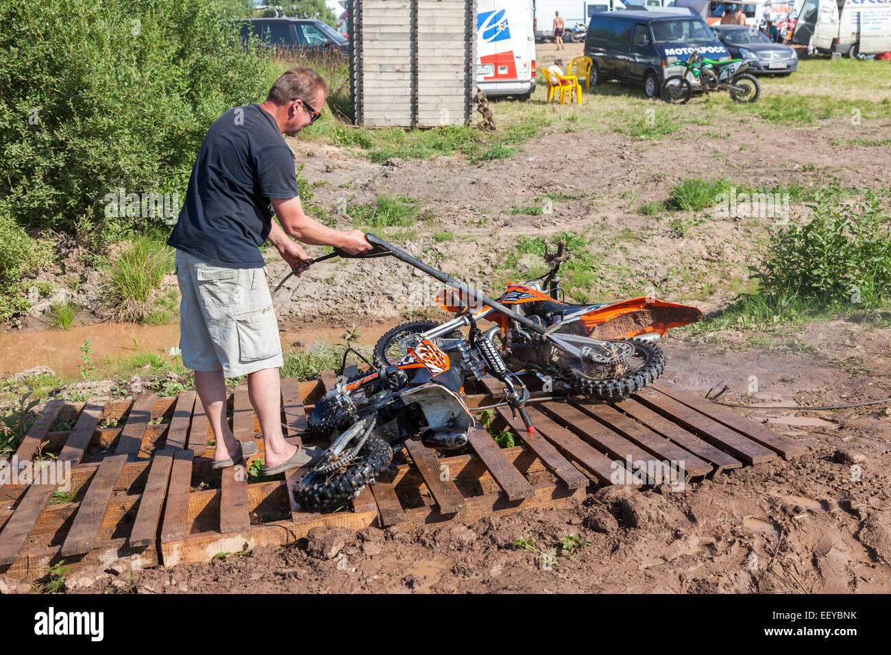 Man washing a race bike after the competition in motocross Stock Photo ...