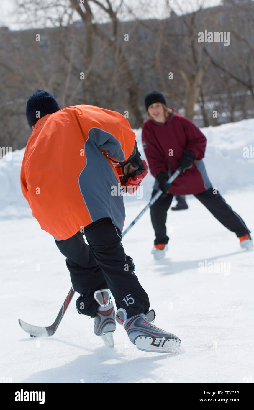 Boys playing ice hockey on an outdoor rink Stock Photo - Alamy