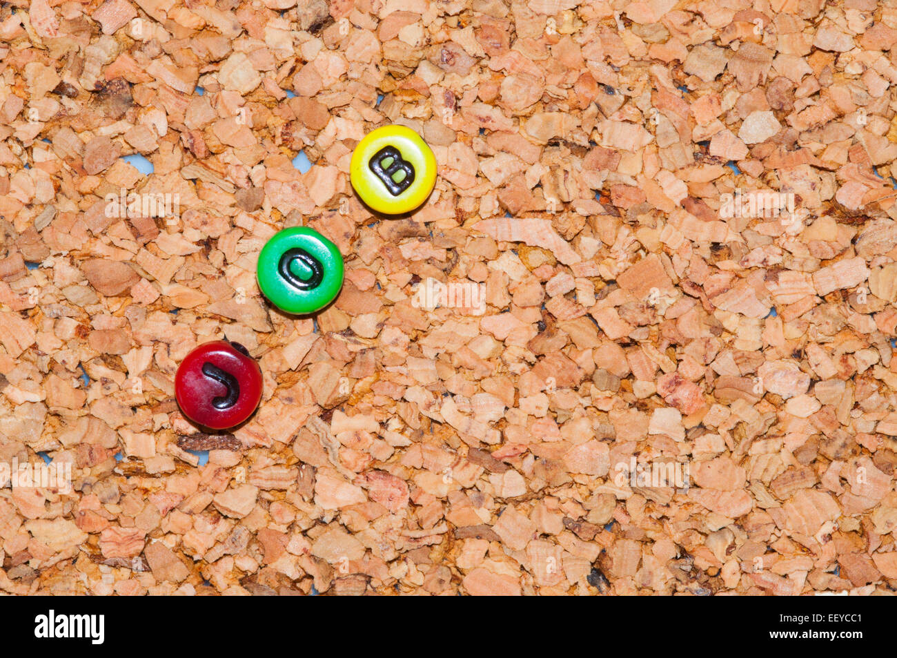 Colored job on cork background Stock Photo - Alamy