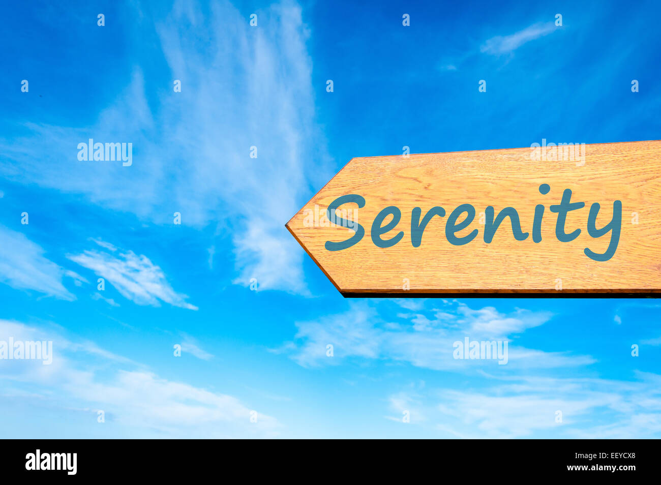 Wood arrow sign against clear blue sky with Serenity message, happiness ...