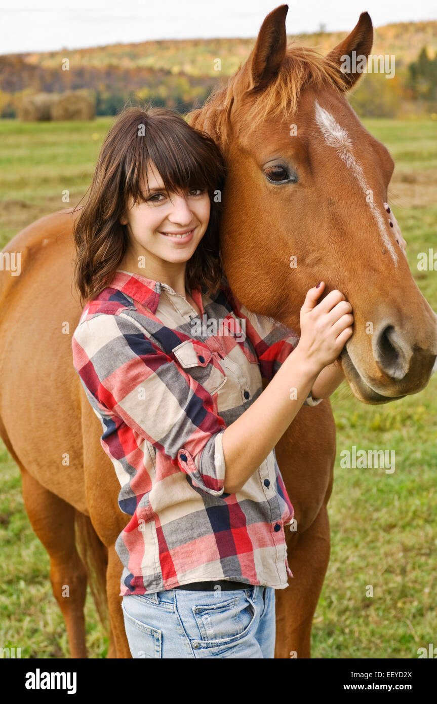 Girl standing beside a horse Stock Photo - Alamy
