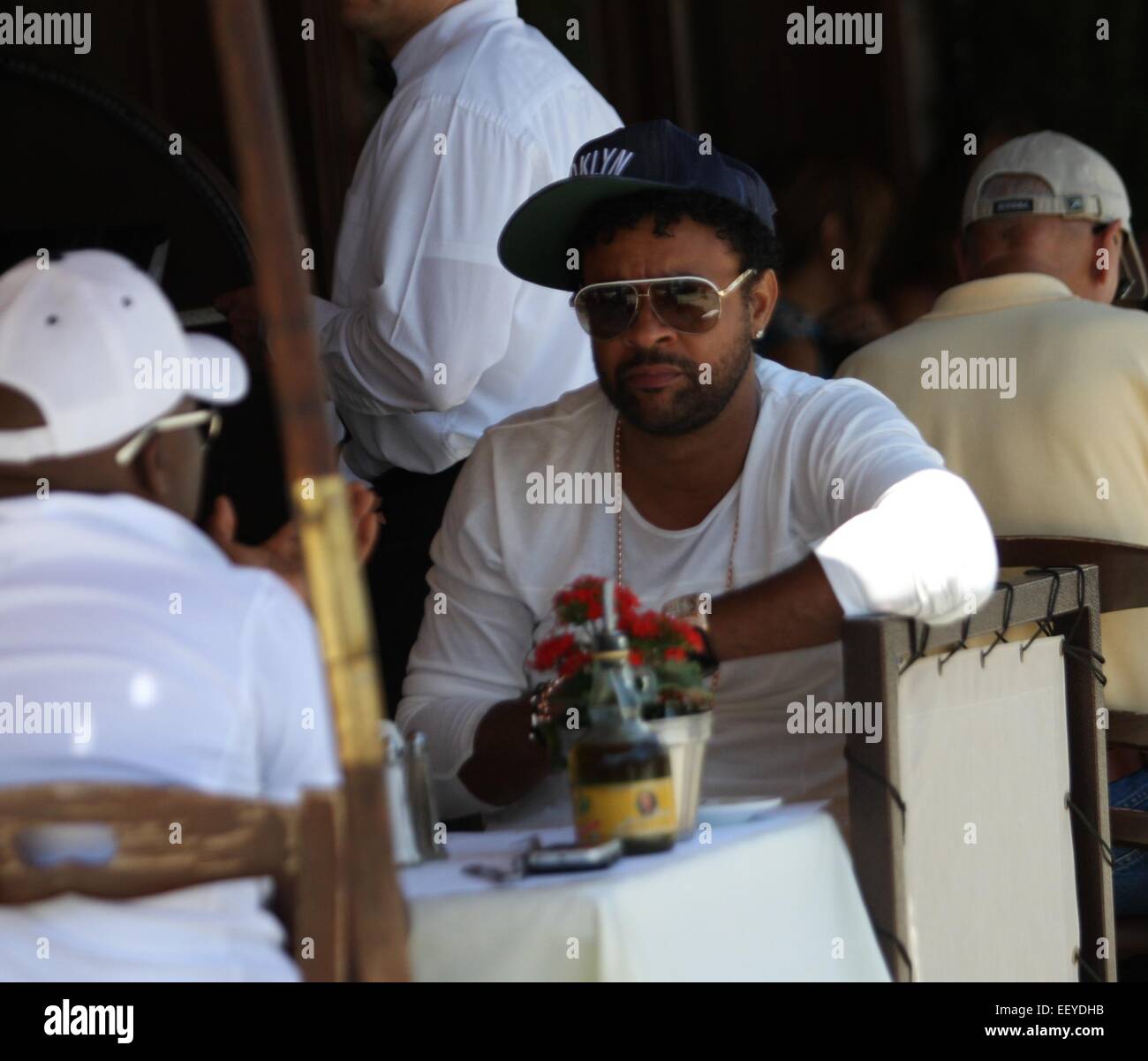 Shaggy, dressed in a Brooklyn cap and aviator sunglasses, has lunch in ...
