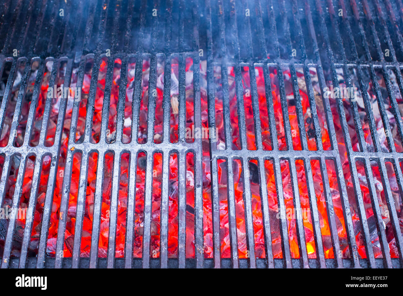 Empty black cast iron grill with hot red glowing coals Stock Photo - Alamy