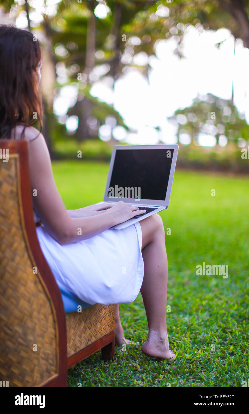 Young woman with laptop during summer vacation Stock Photo - Alamy