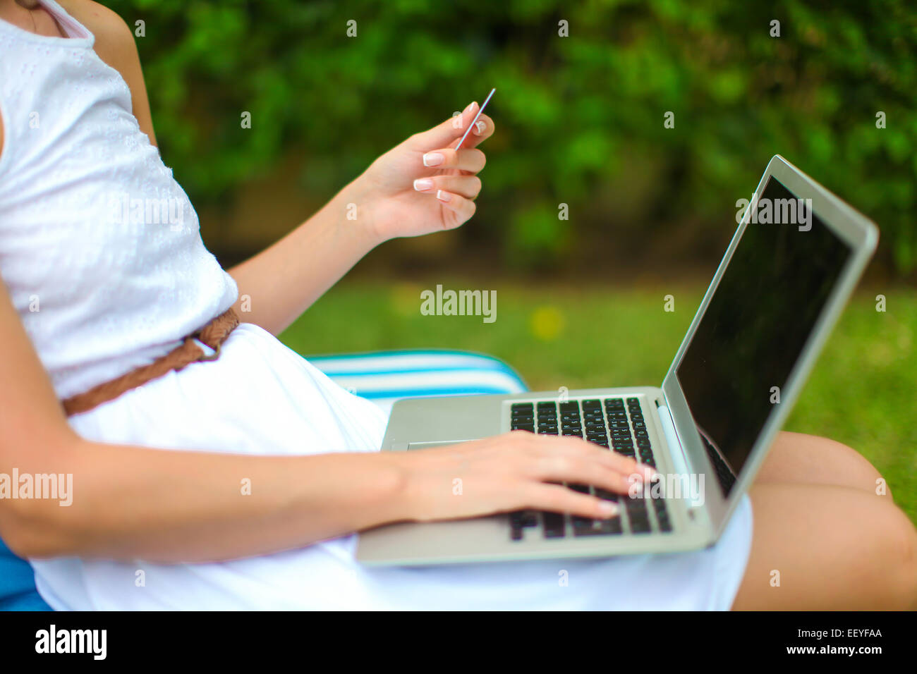 Young woman with laptop during summer vacation Stock Photo - Alamy