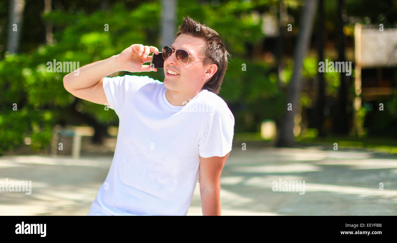 Businessman talking cellphone on beach hi-res stock photography and ...