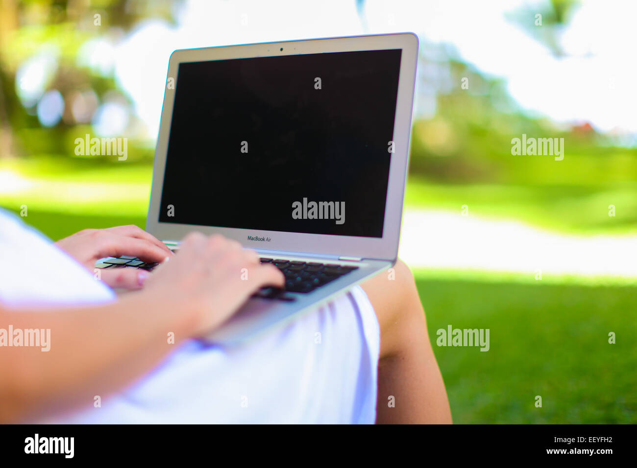 Young woman with laptop during summer vacation Stock Photo - Alamy