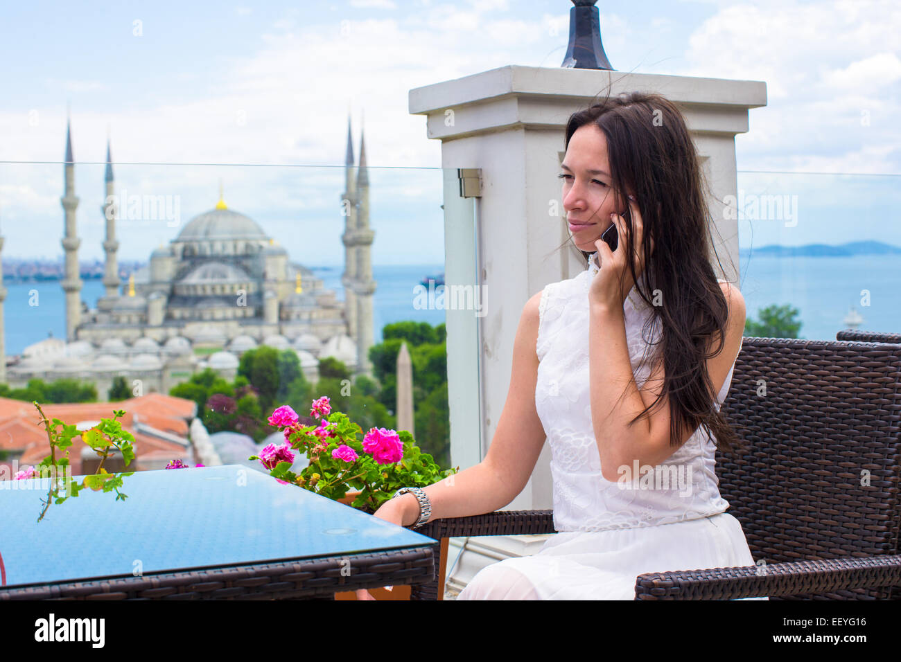 Young woman on terrace with stunning view of the city Stock Photo - Alamy