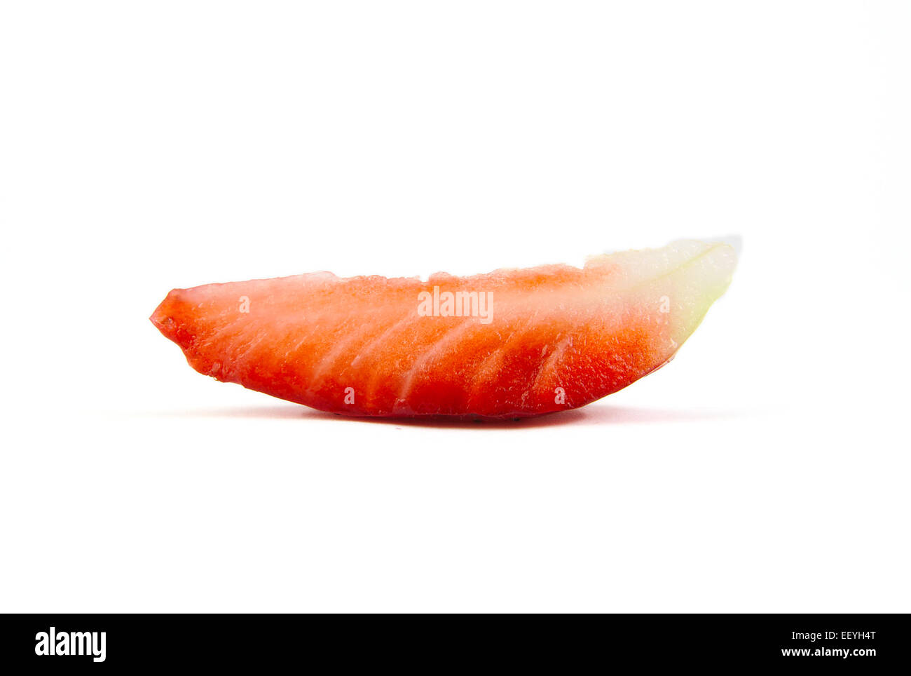 Slice of strawberry on white background Stock Photo - Alamy
