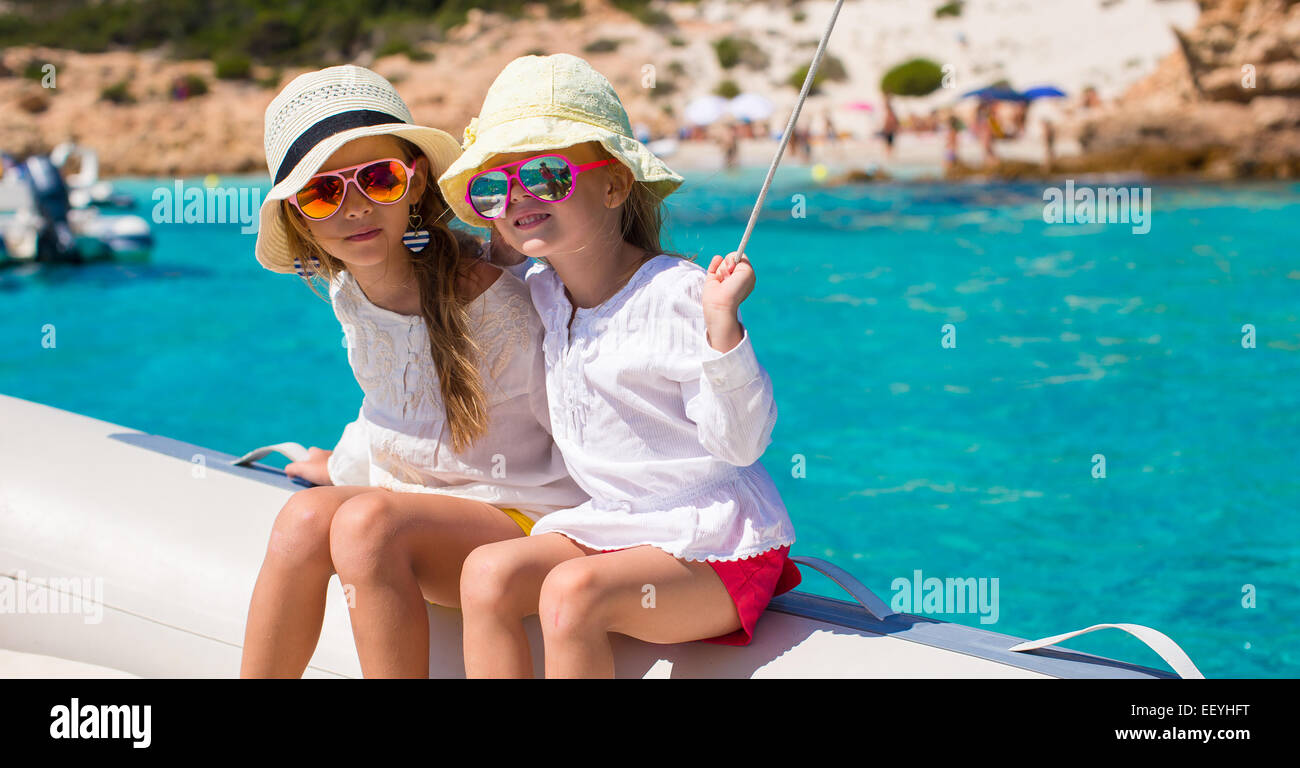 Little cute girls enjoying sailing on boat in the open sea Stock Photo ...
