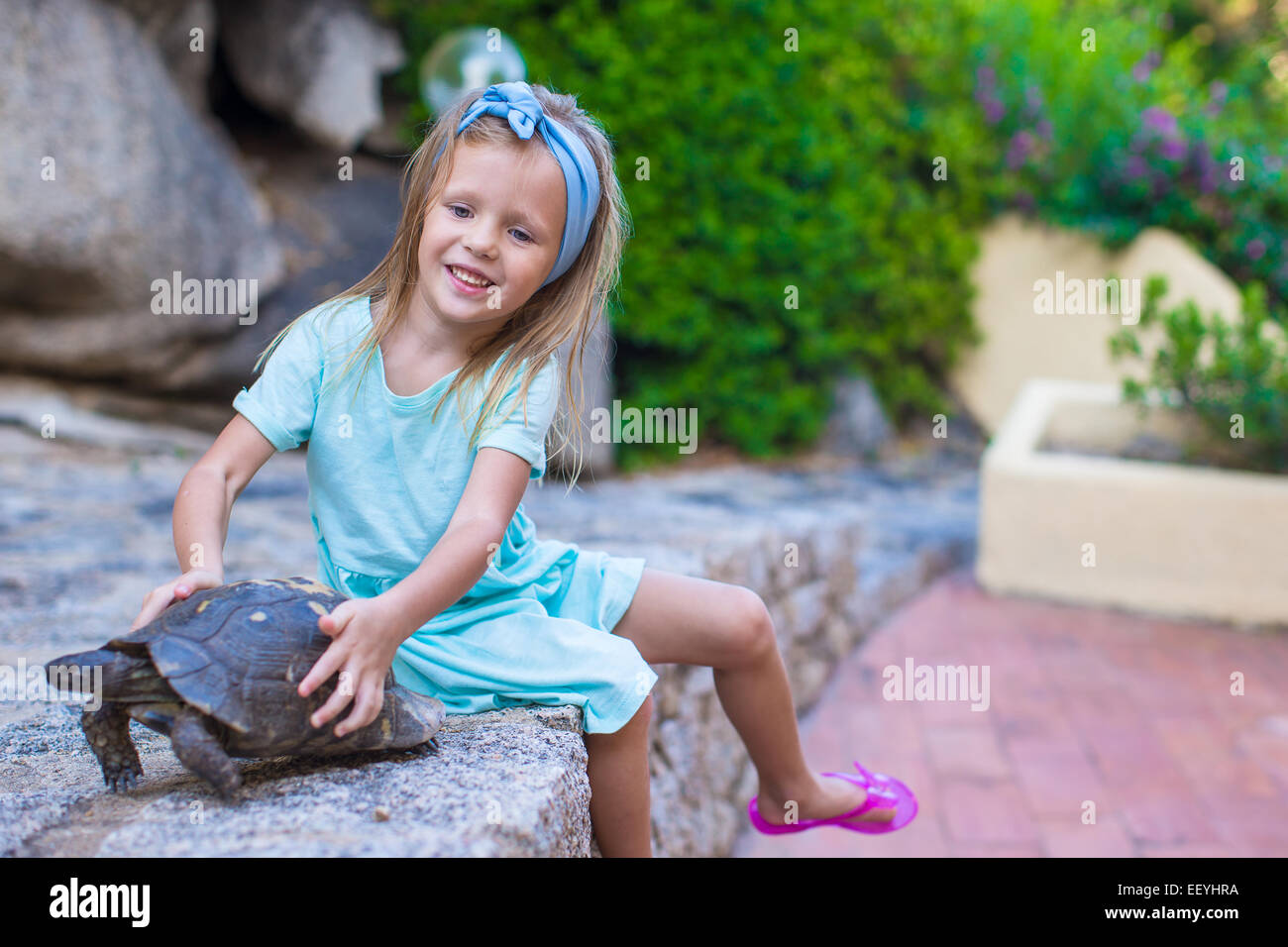 Little adorble happy girl with small turtle outdoors Stock Photo - Alamy