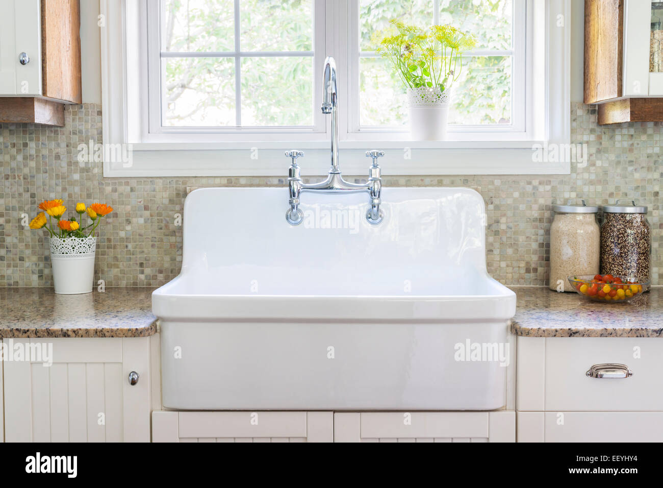 Kitchen interior with large rustic white porcelain sink and granite ...