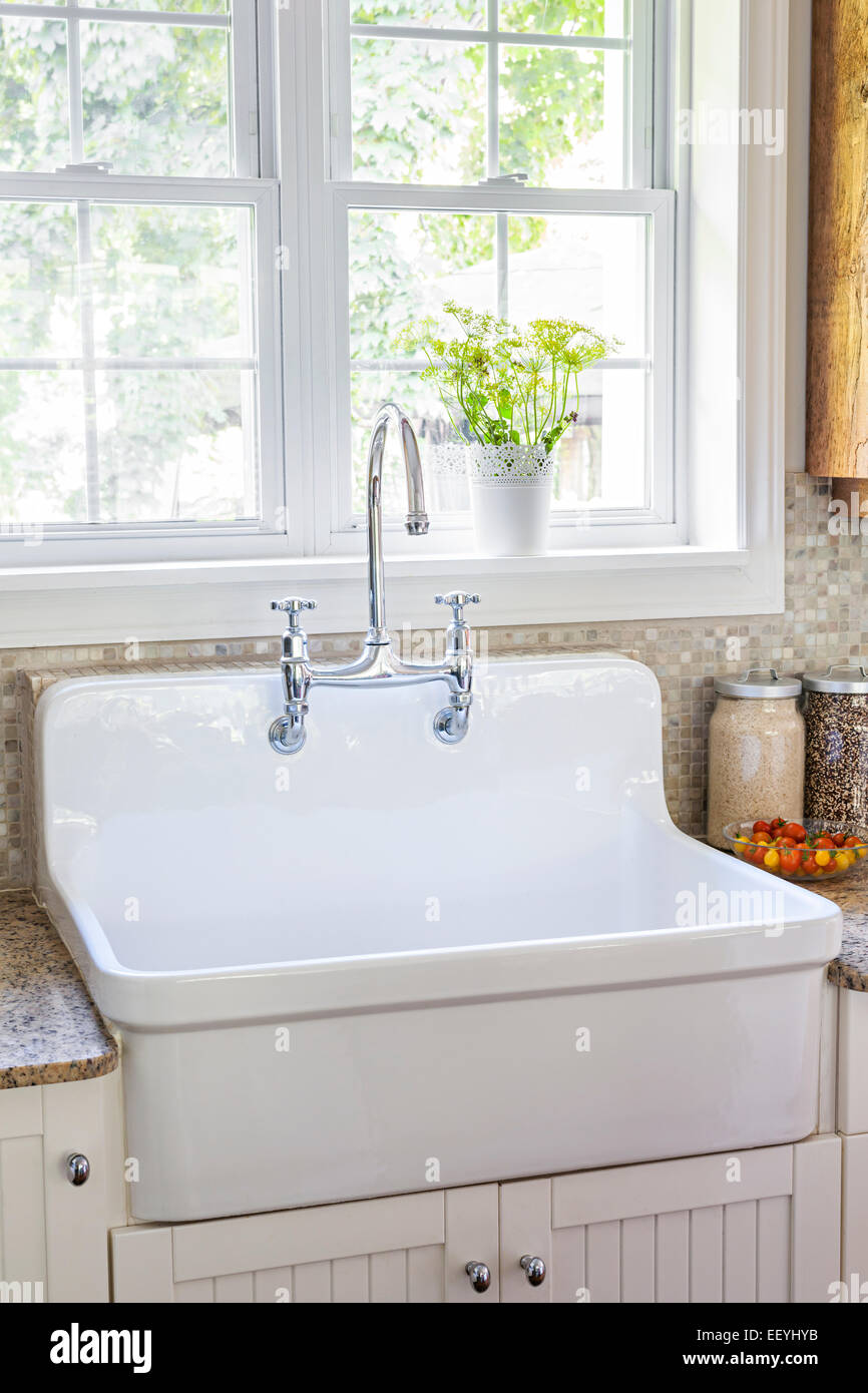 Kitchen interior with rustic white porcelain sink and granite stone ...