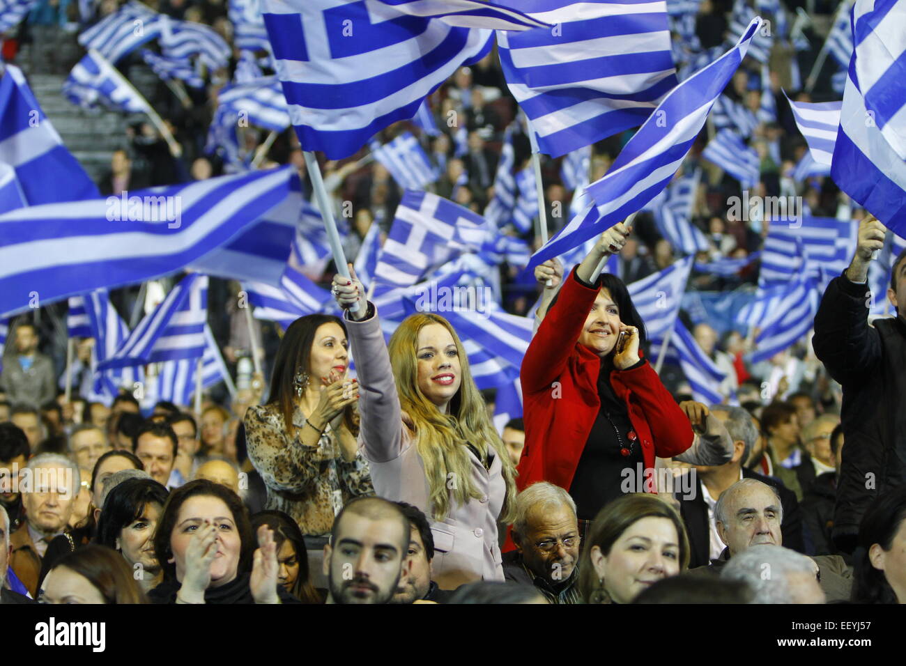 Two women wave Greek flags. Néa Dimokratía, the current main government ...