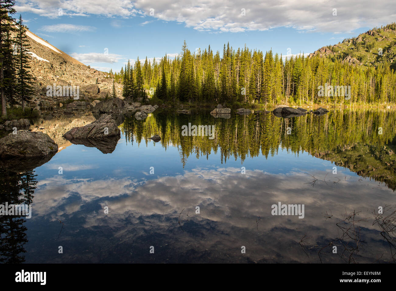 A beautiful alpine lake glows in the morning light, deep in the Swan ...