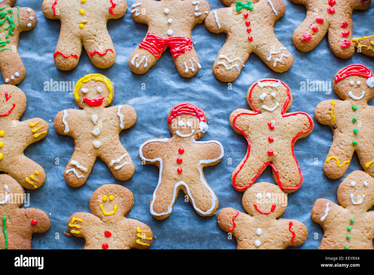 Raw gingerbread men with glaze on baking sheet for Christmas time Stock ...