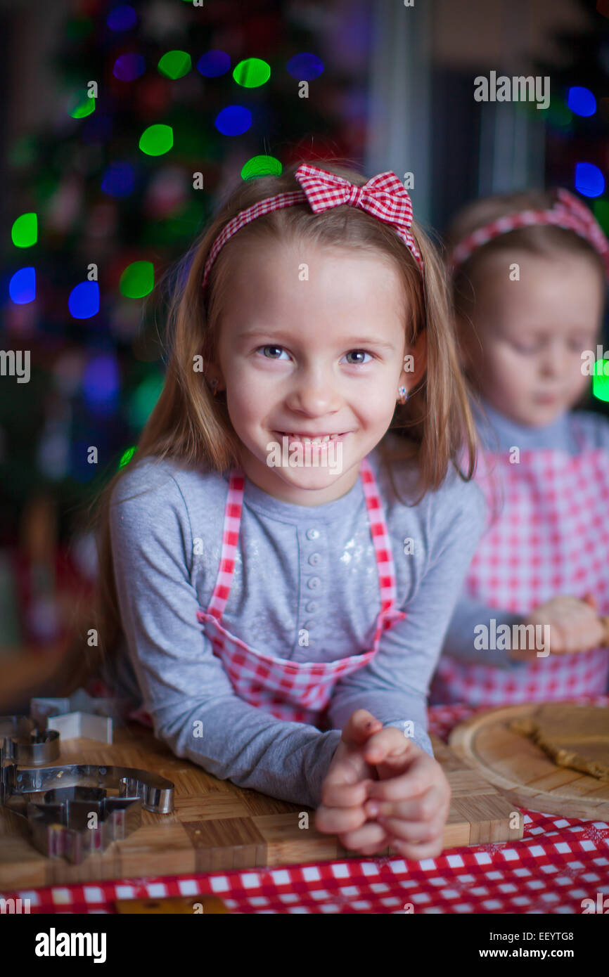 Little girls in mittens baking Christmas gingerbread cookies Stock ...