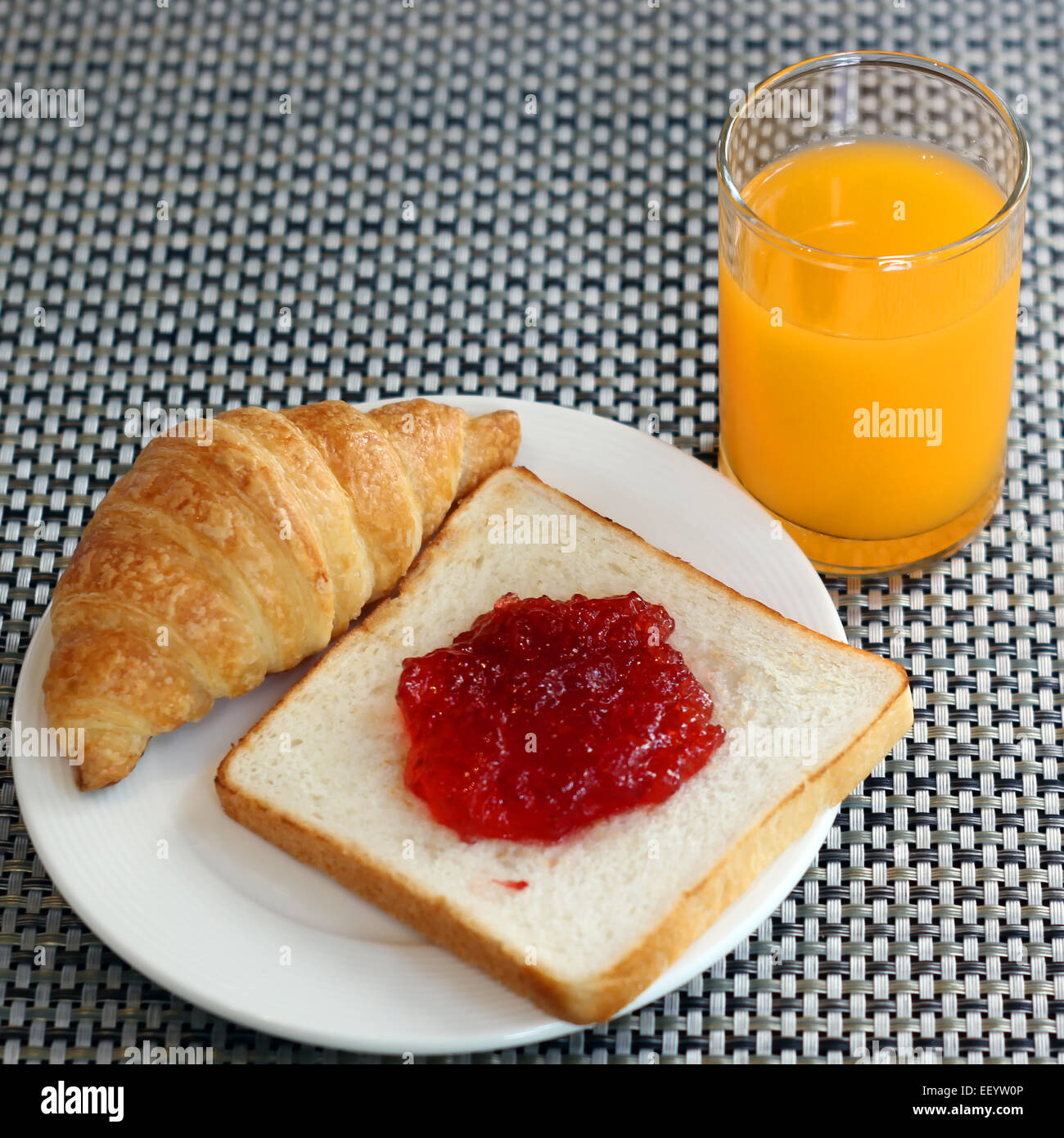 strawberry jam on bread, croissant and orange juice Stock Photo - Alamy