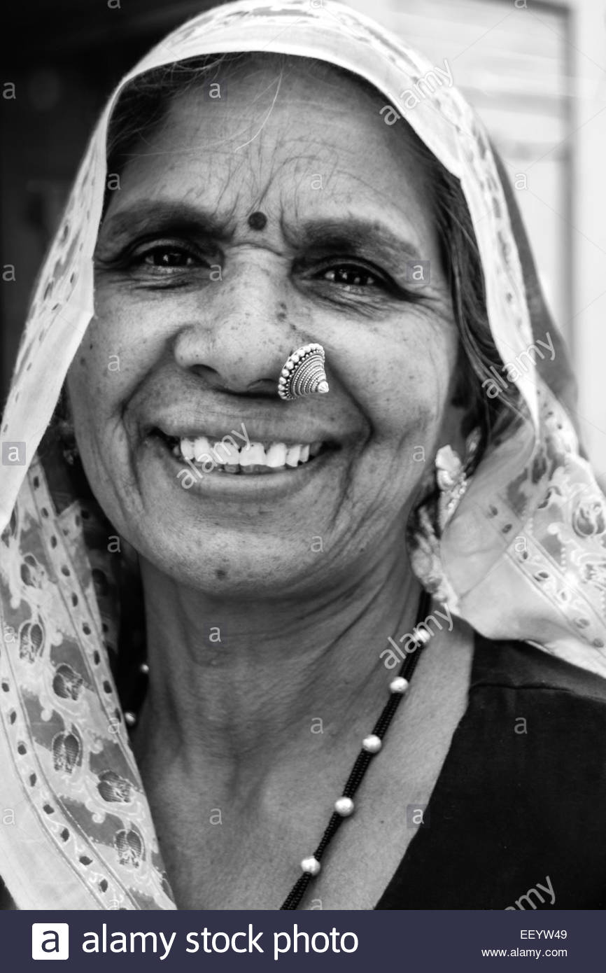 An old lady, dressed in traditional Indian attire, smiling & looking ...
