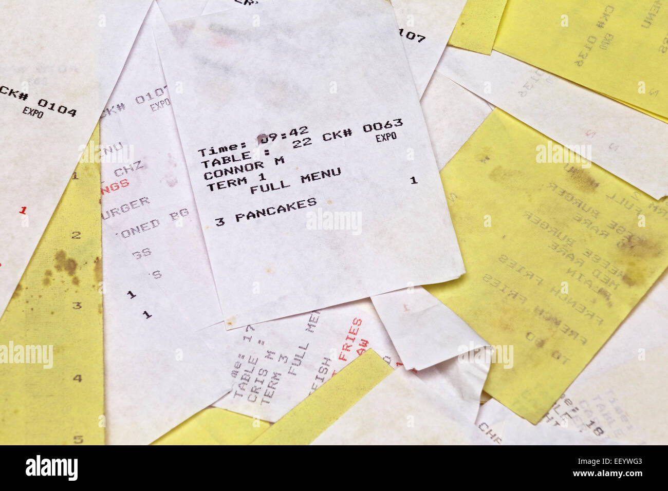 Grease stained restaurant guest food order tickets in pile Stock Photo ...