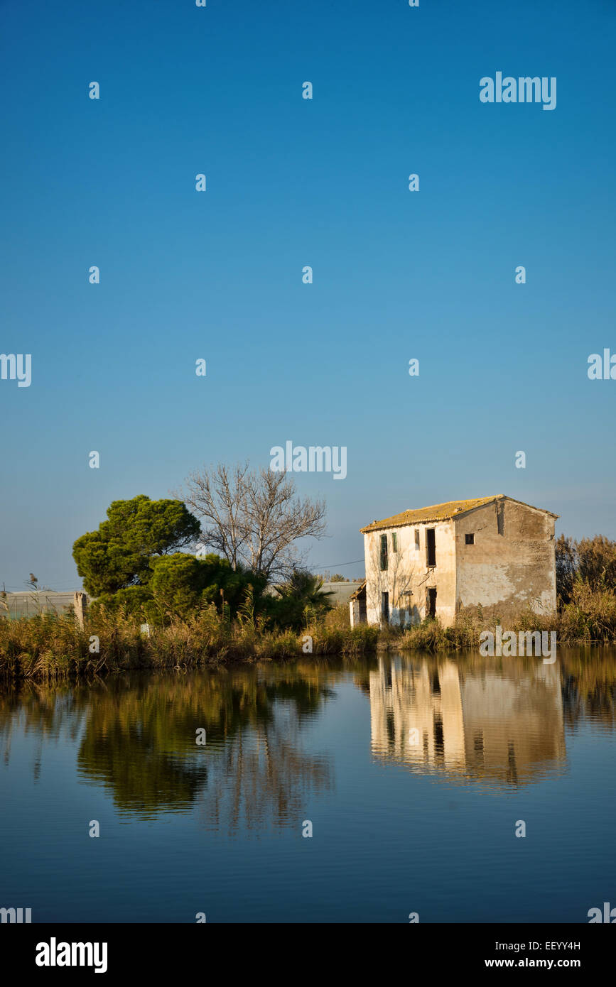 Old farmhouse and its reflection in Albufera lagoon, Valencia, Spain ...