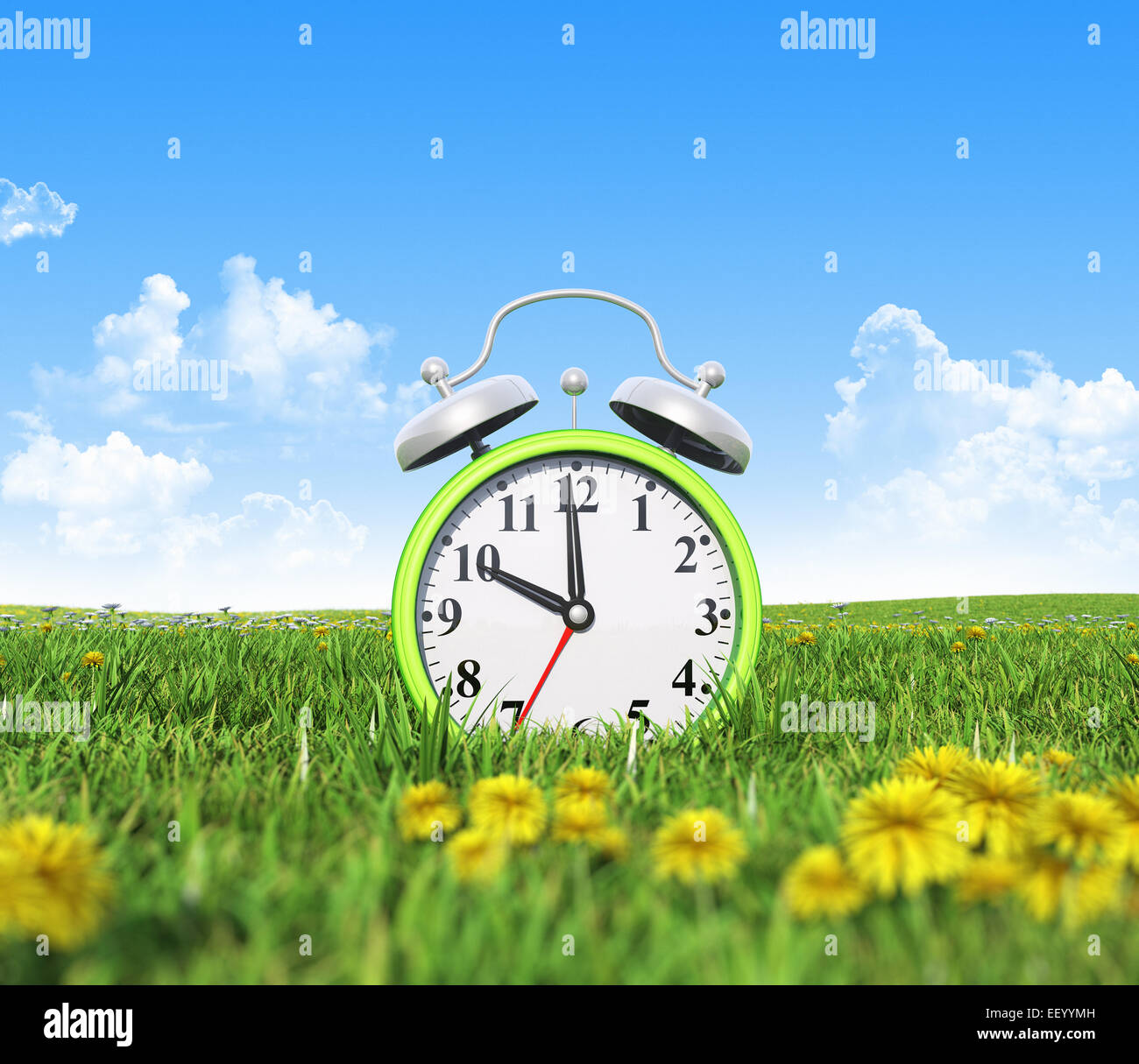 Alarm clock on the green grass field Stock Photo - Alamy