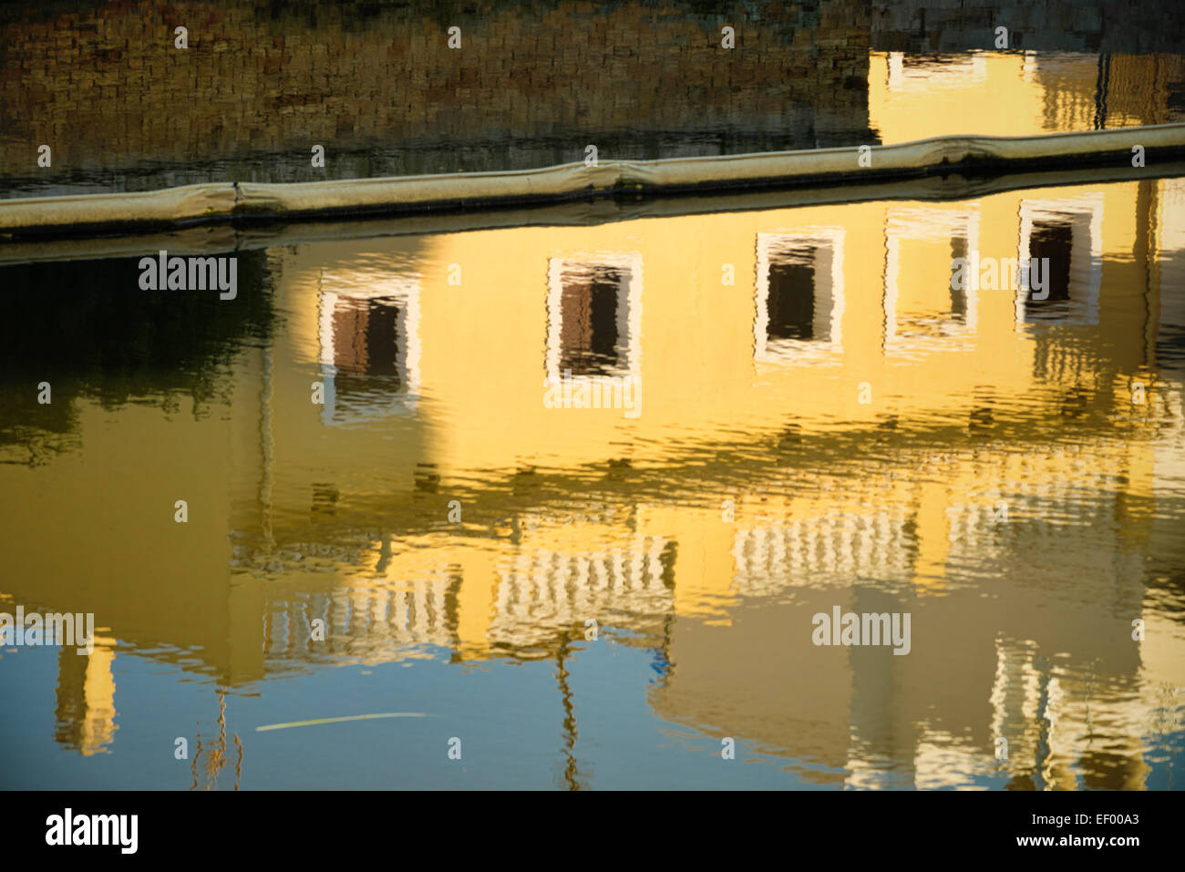 Traditional farmhouse reflected in the calm waters of Albufera lagoon ...