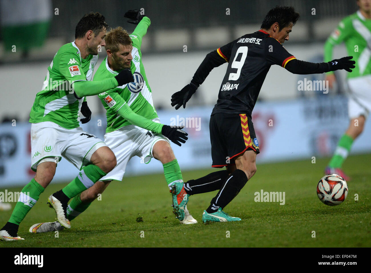 Wolfsburg, Germany. 23rd Jan, 2015. Karlsruhe's Hiroki Yamada (r) and ...