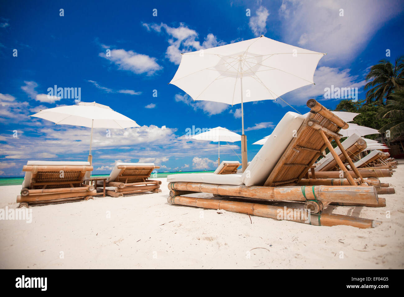 Beach wooden chairs for vacations on tropical beach Stock Photo - Alamy