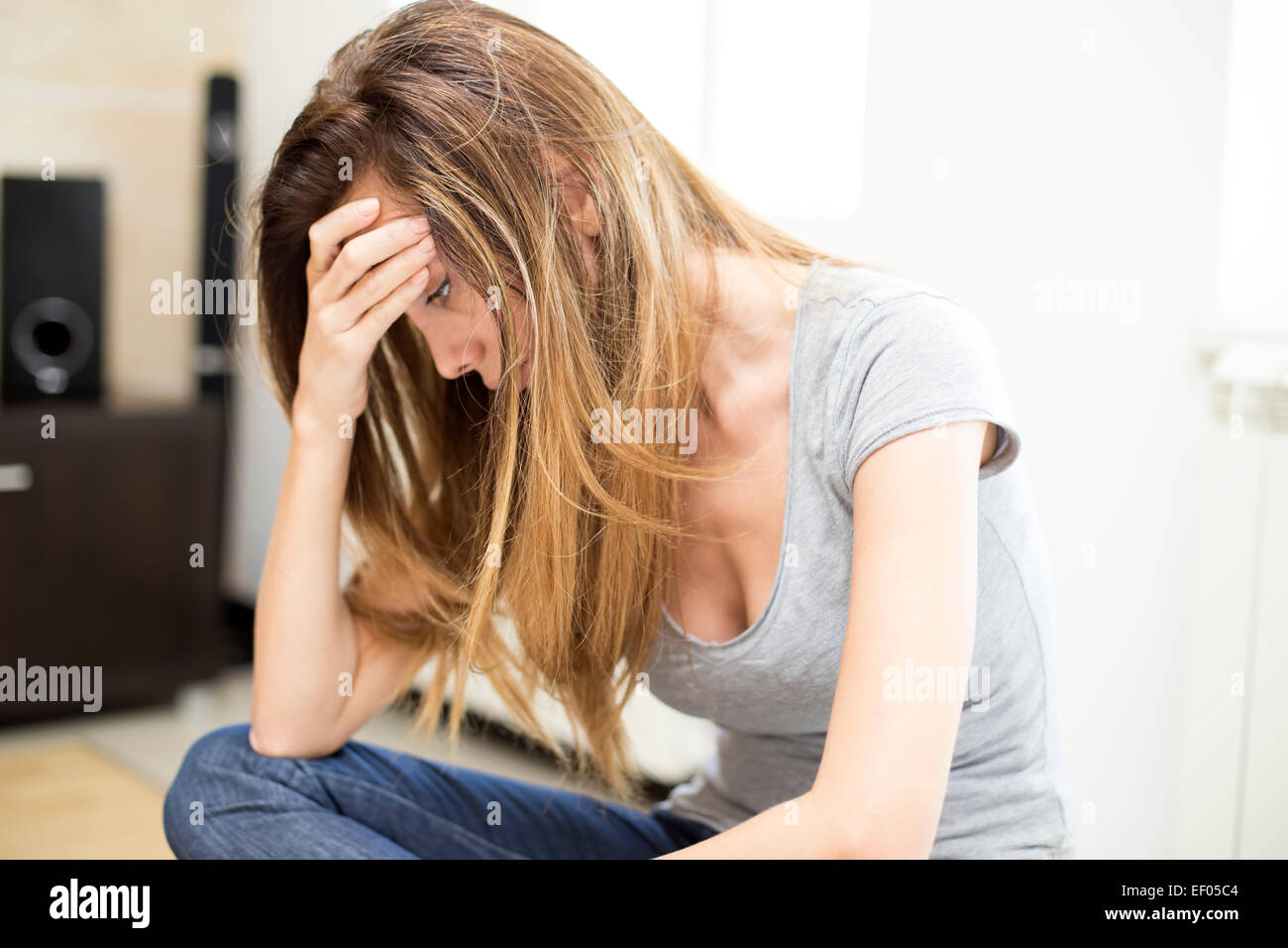 Sad woman in the room Stock Photo - Alamy