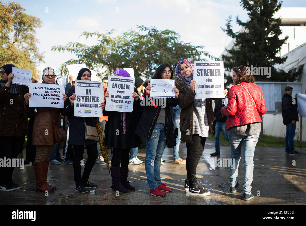 Student holds placards in her hands which reads in different languages ...