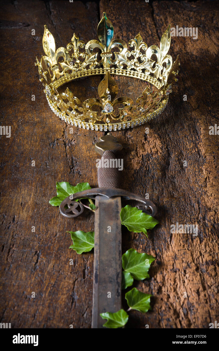 Antique medieval sword and golden crown decorated with ivy Stock Photo ...