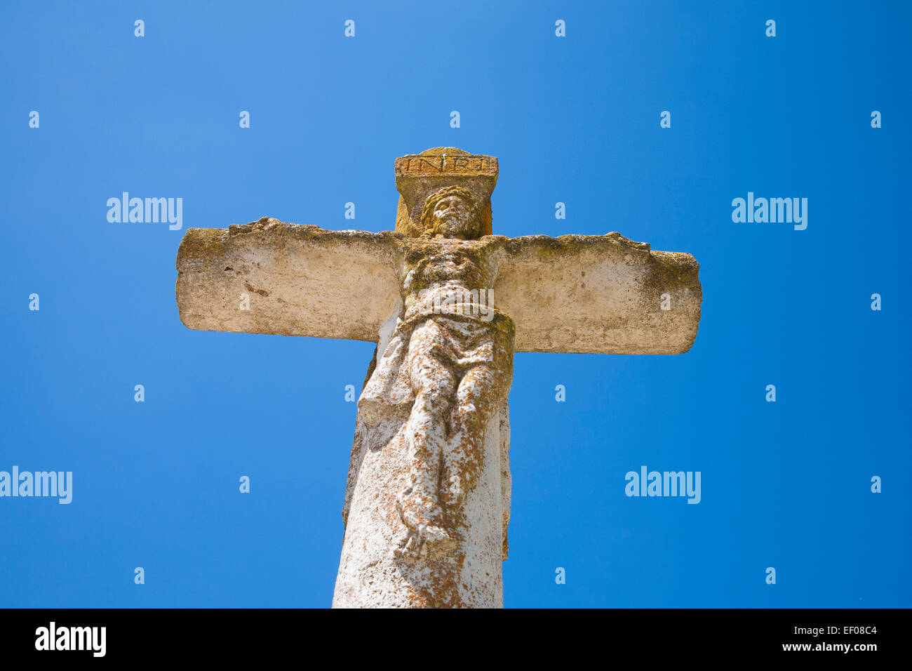 ancient white stone crucifix with Jesus in blue sky Stock Photo - Alamy