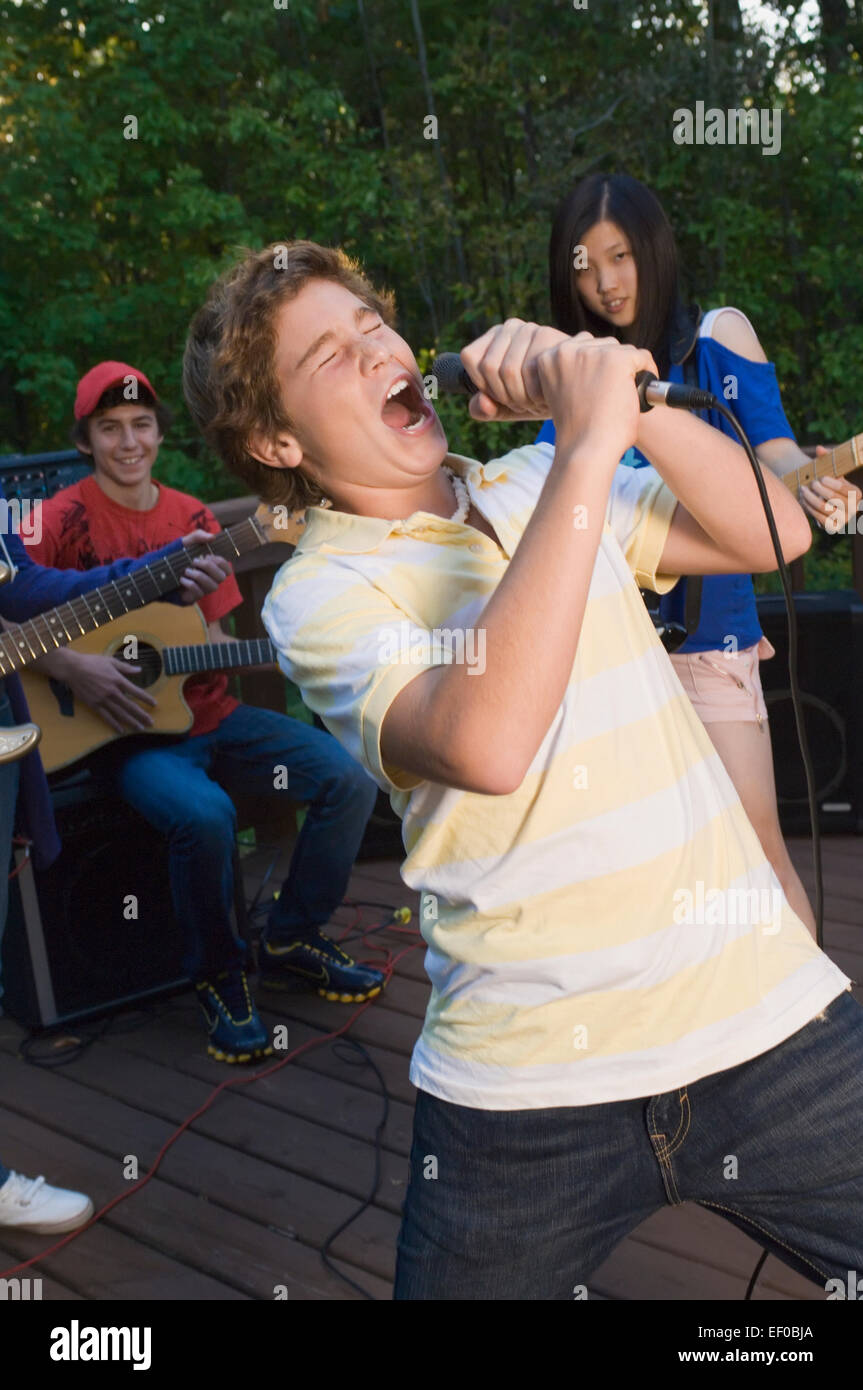 Teenage band playing on an outdoor deck Stock Photo - Alamy