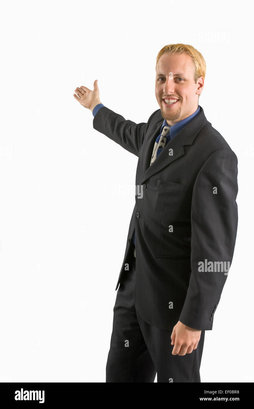 Businessman extending his arm towards a blank wall Stock Photo - Alamy