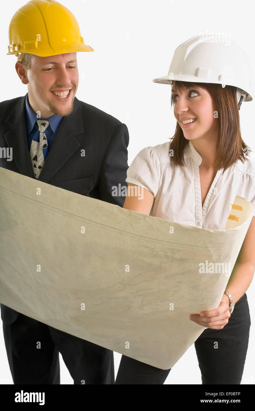 Two architects looking at blueprints Stock Photo - Alamy