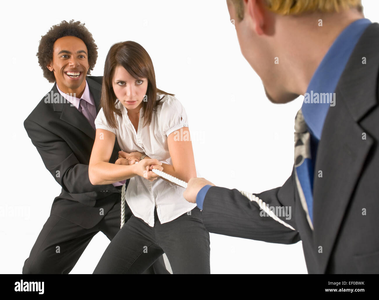 Three business people having a tug of war Stock Photo - Alamy