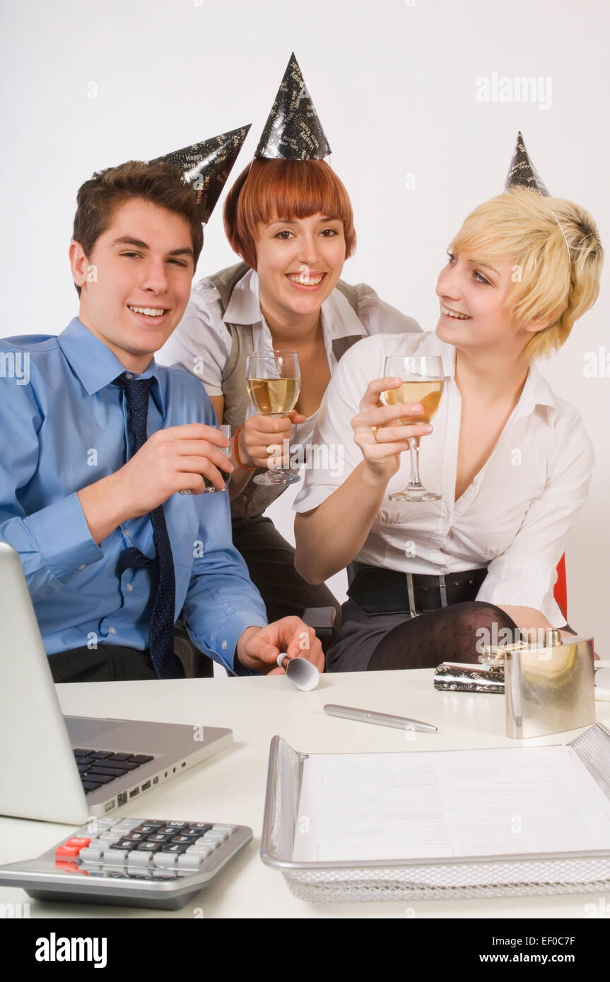 Three business people drinking wine at work Stock Photo - Alamy