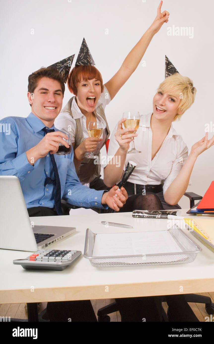 Three business people drinking wine at work Stock Photo - Alamy
