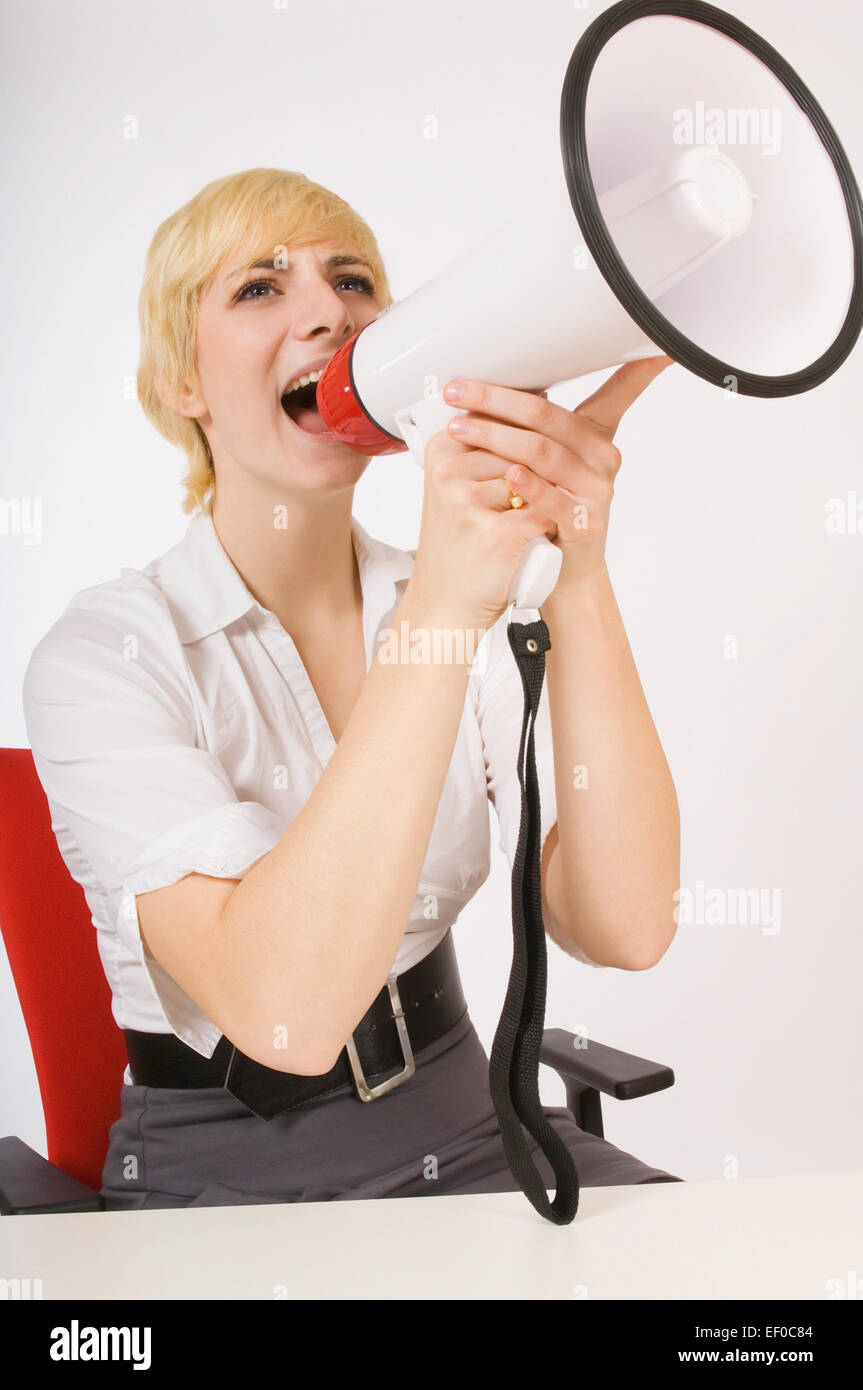 Blond yelling into a bullhorn Stock Photo - Alamy