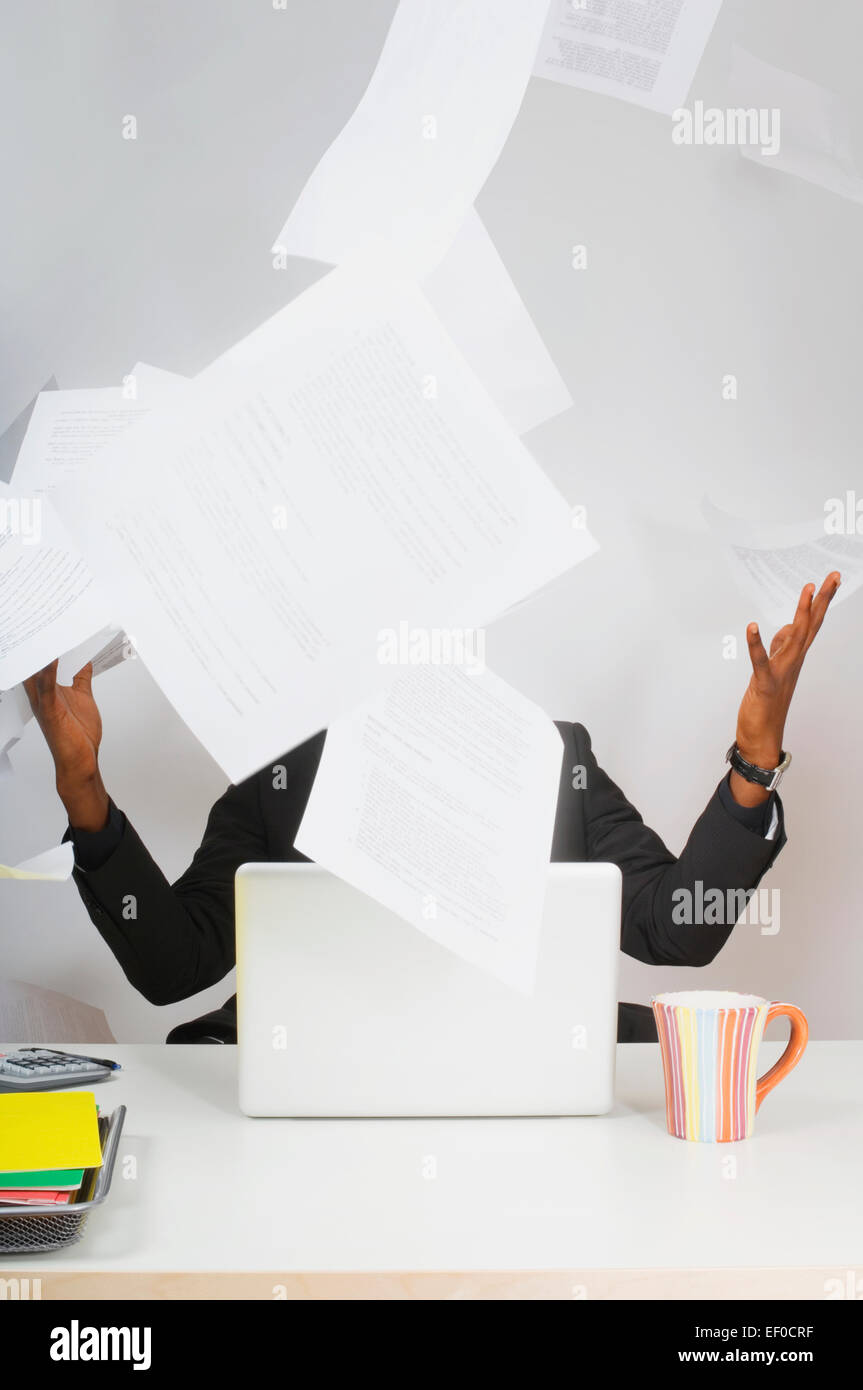 Businessman throwing paperwork in the air Stock Photo - Alamy