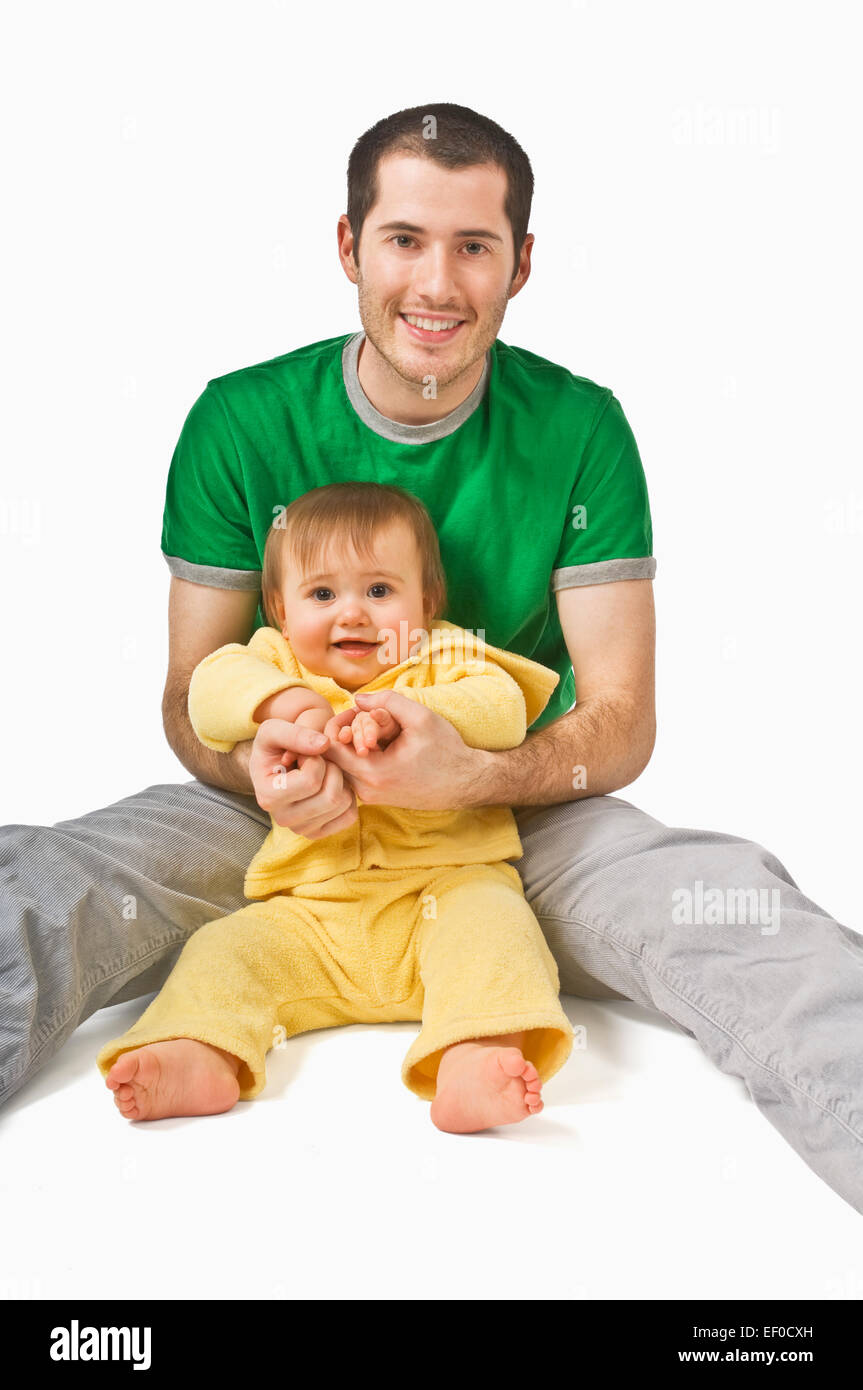 Father sitting on the floor with his young son Stock Photo - Alamy