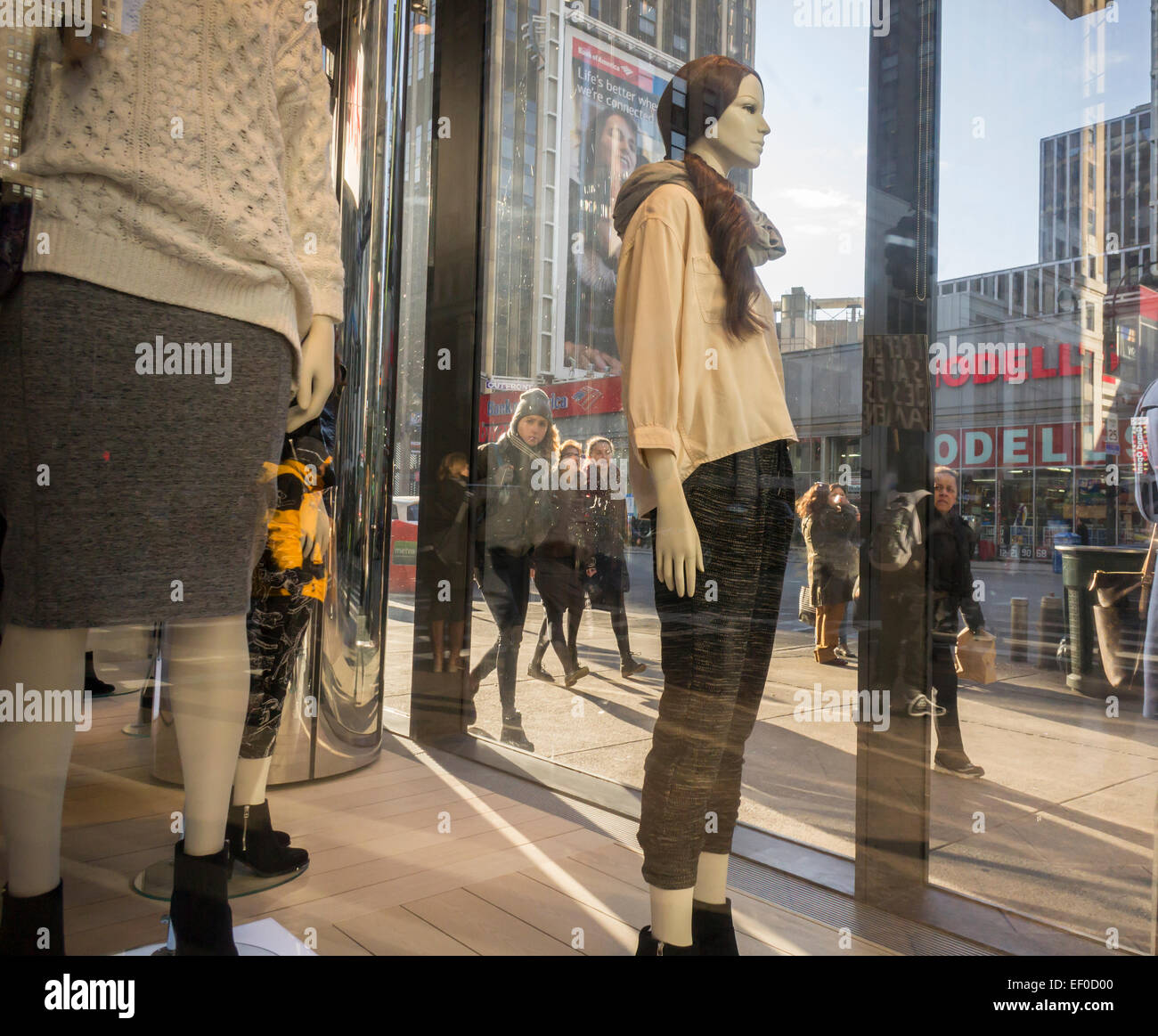 Crowds pass an H&M window display in New York on Thursday, January 22 ...