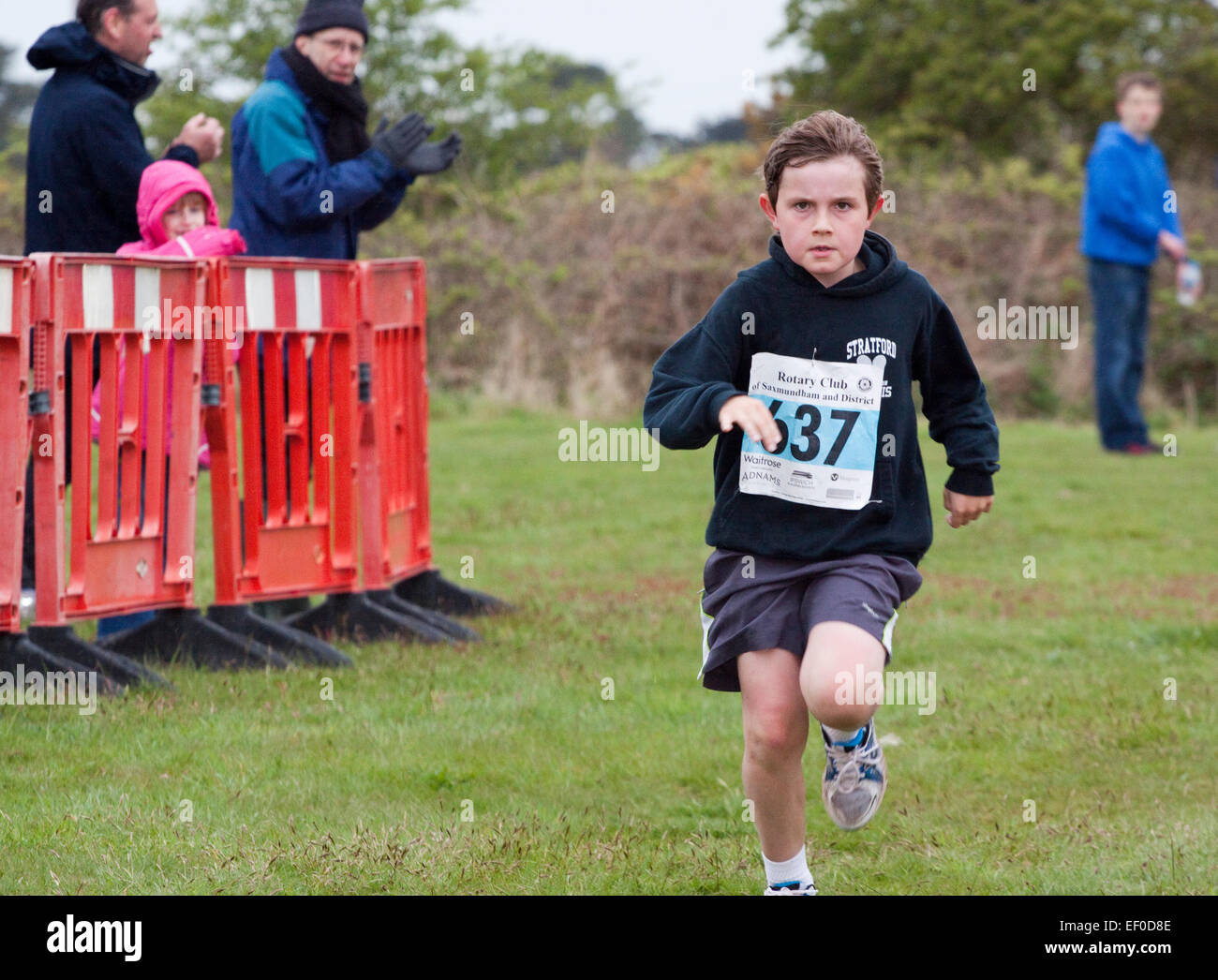 Young runner at the end of a cross-country race has very determined ...