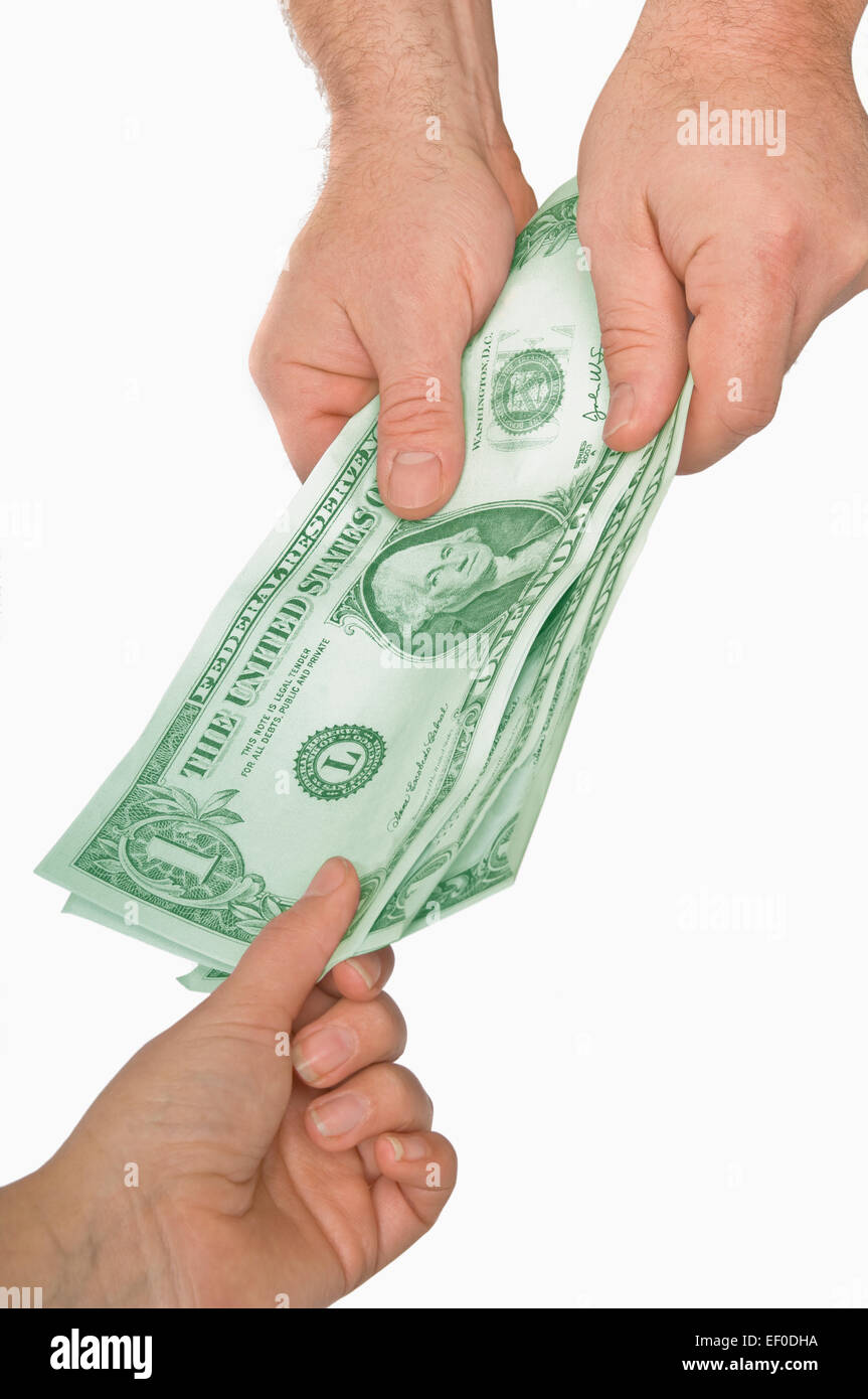 Hands pulling dollar bills from another hand Stock Photo - Alamy