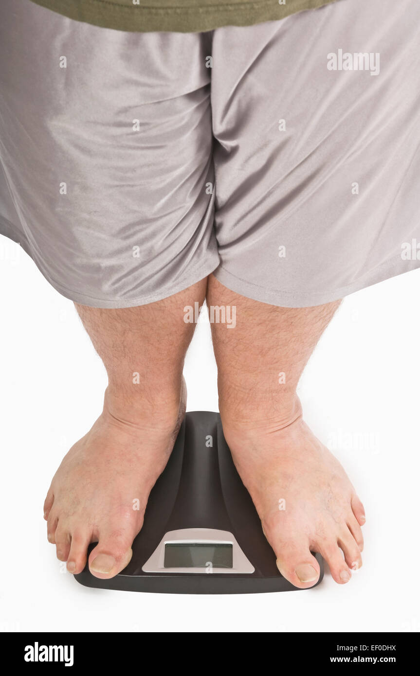 Legs and feet on a scale Stock Photo - Alamy