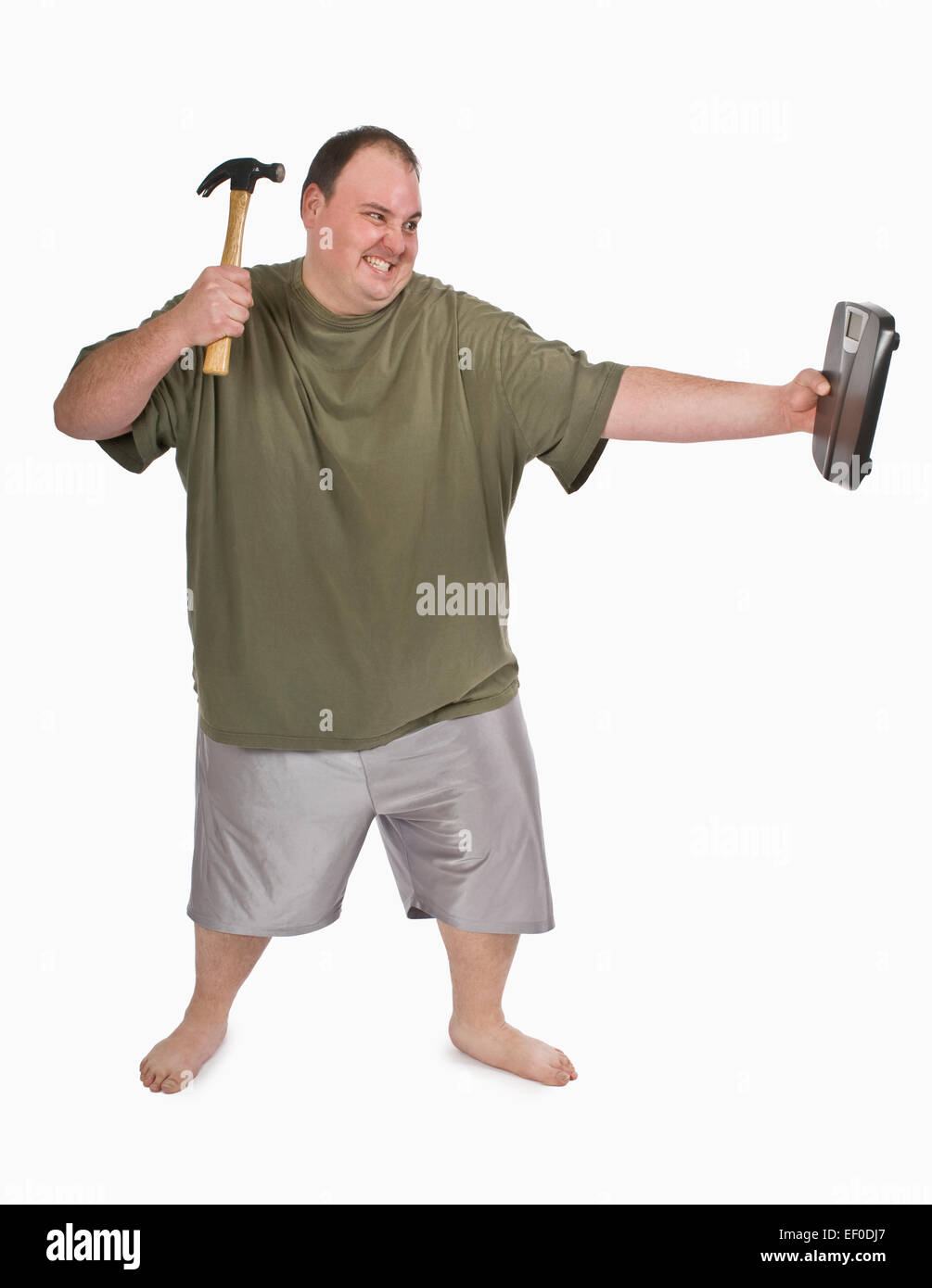 Overweight man about to hit a scale with a hammer Stock Photo - Alamy