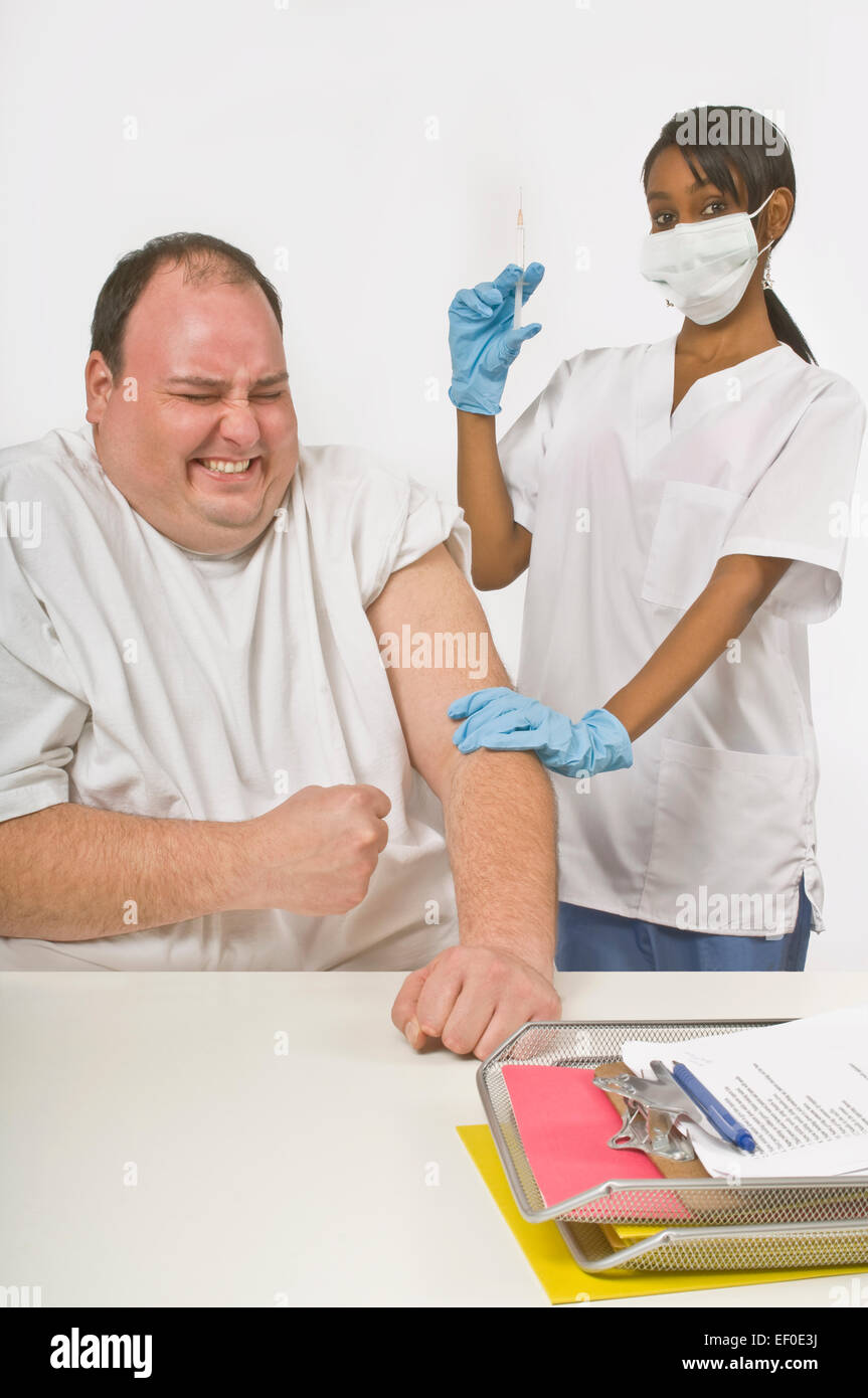 Nurse giving overweight man a needle Stock Photo - Alamy